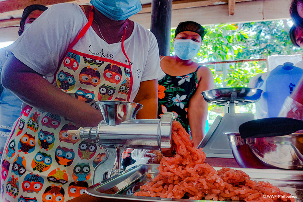 a-woman-grinds-fish-meat-to-be-processed-and-made-into-packaged-food ...